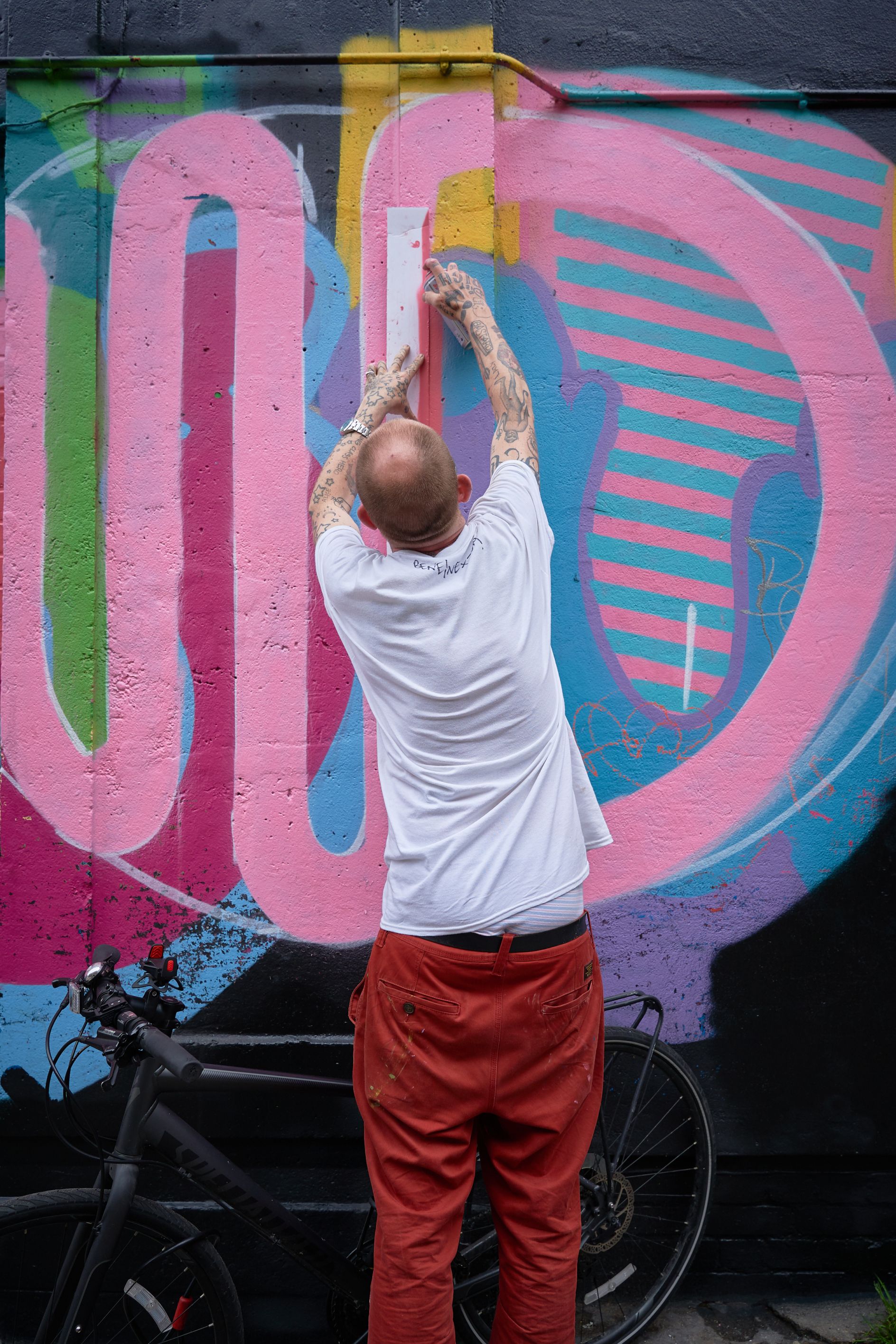 Street artist Ben Eine paints a huge 'Love' mural to bring a little ...