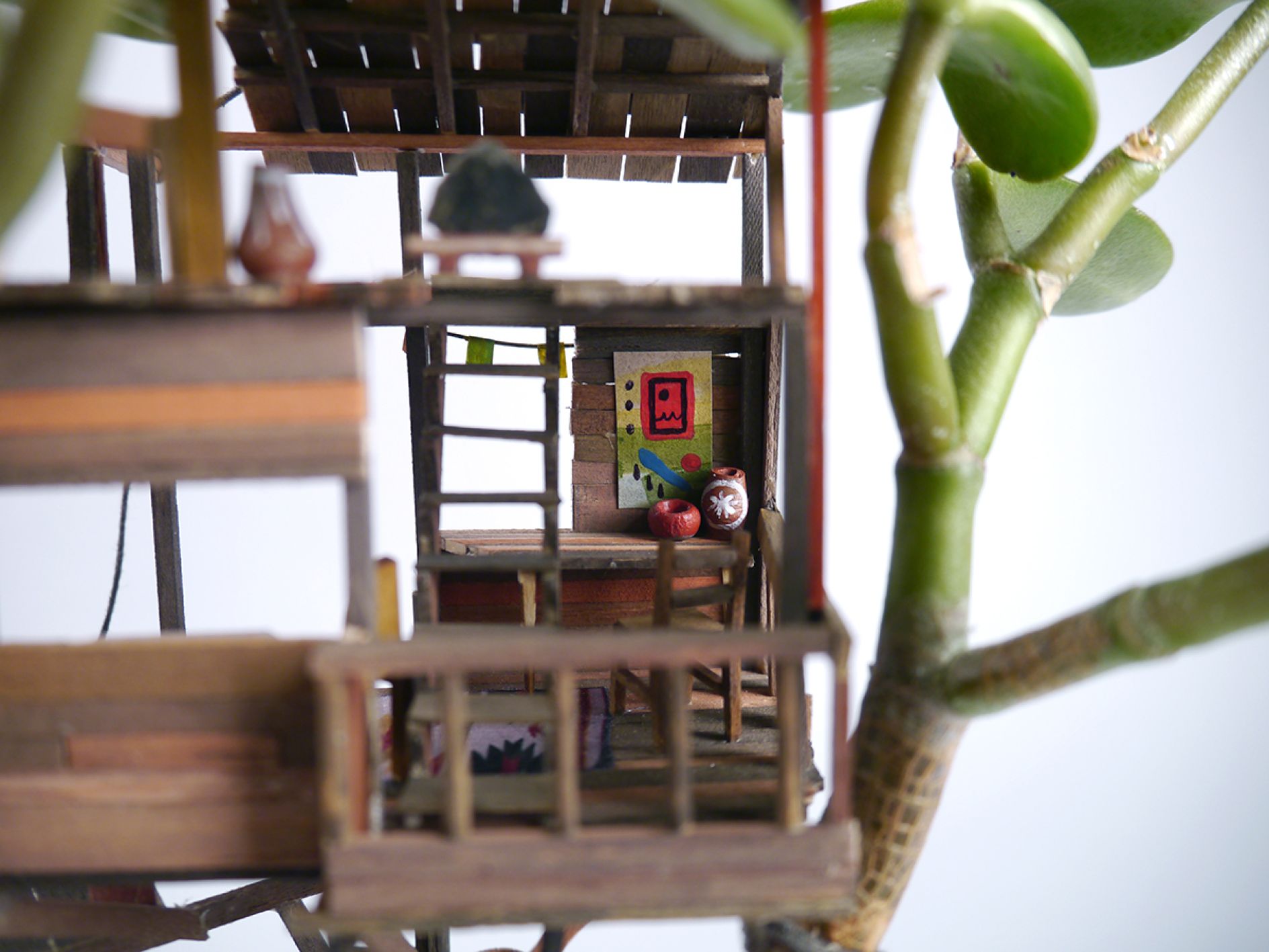 Artist crafts miniature treehouse sculptures to sit within ordinary ...
