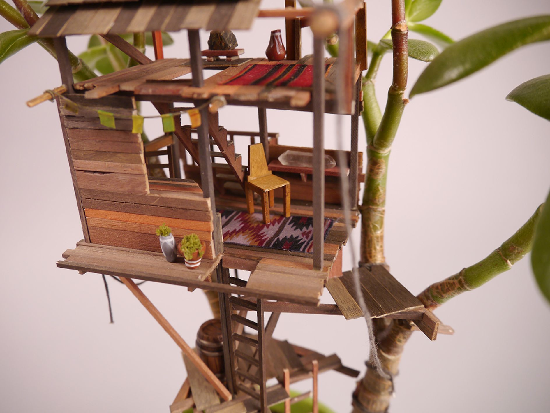 Artist crafts miniature treehouse sculptures to sit within ordinary ...