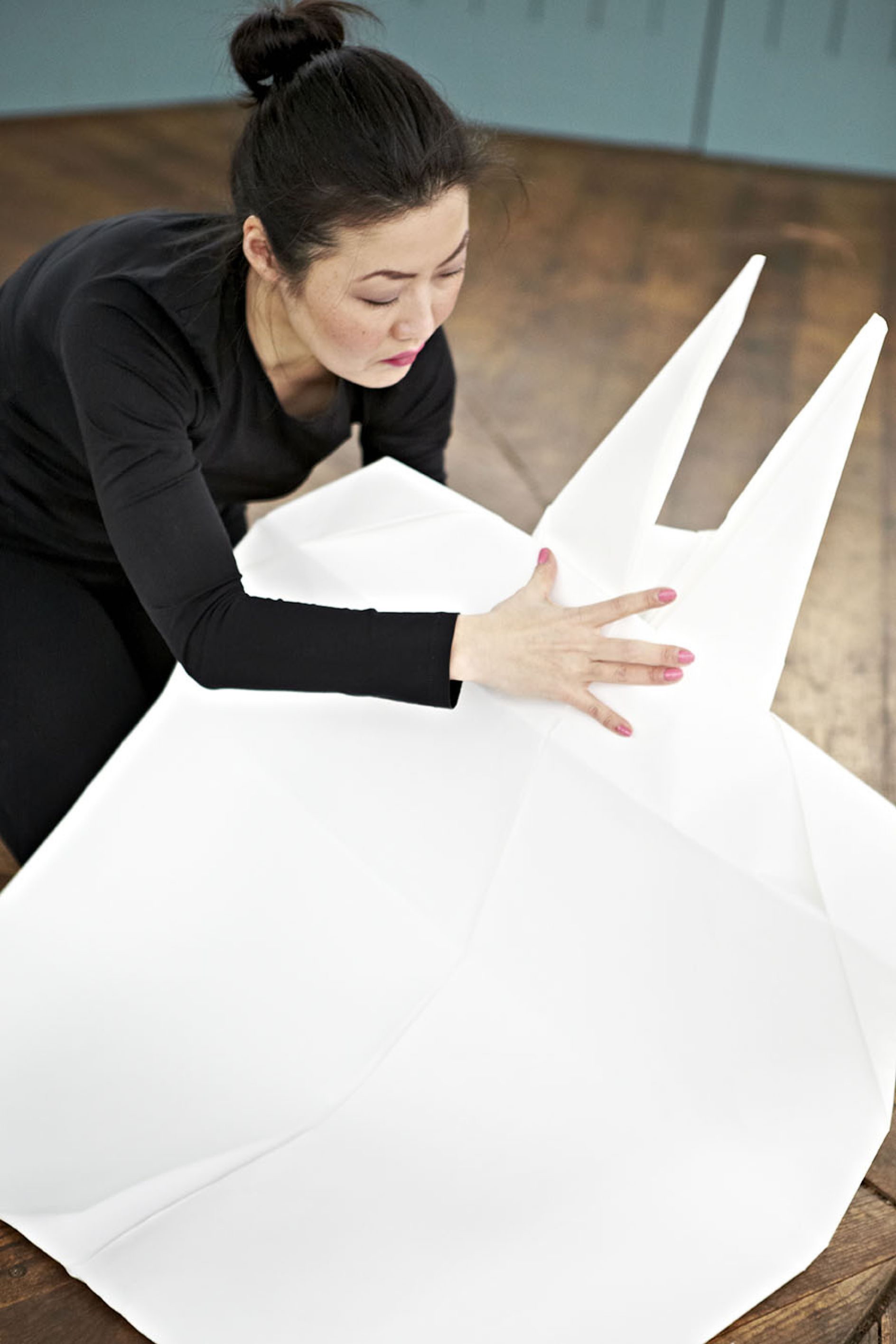 Artist Coco Sato folds a larger-than-life, giant origami rabbit ...