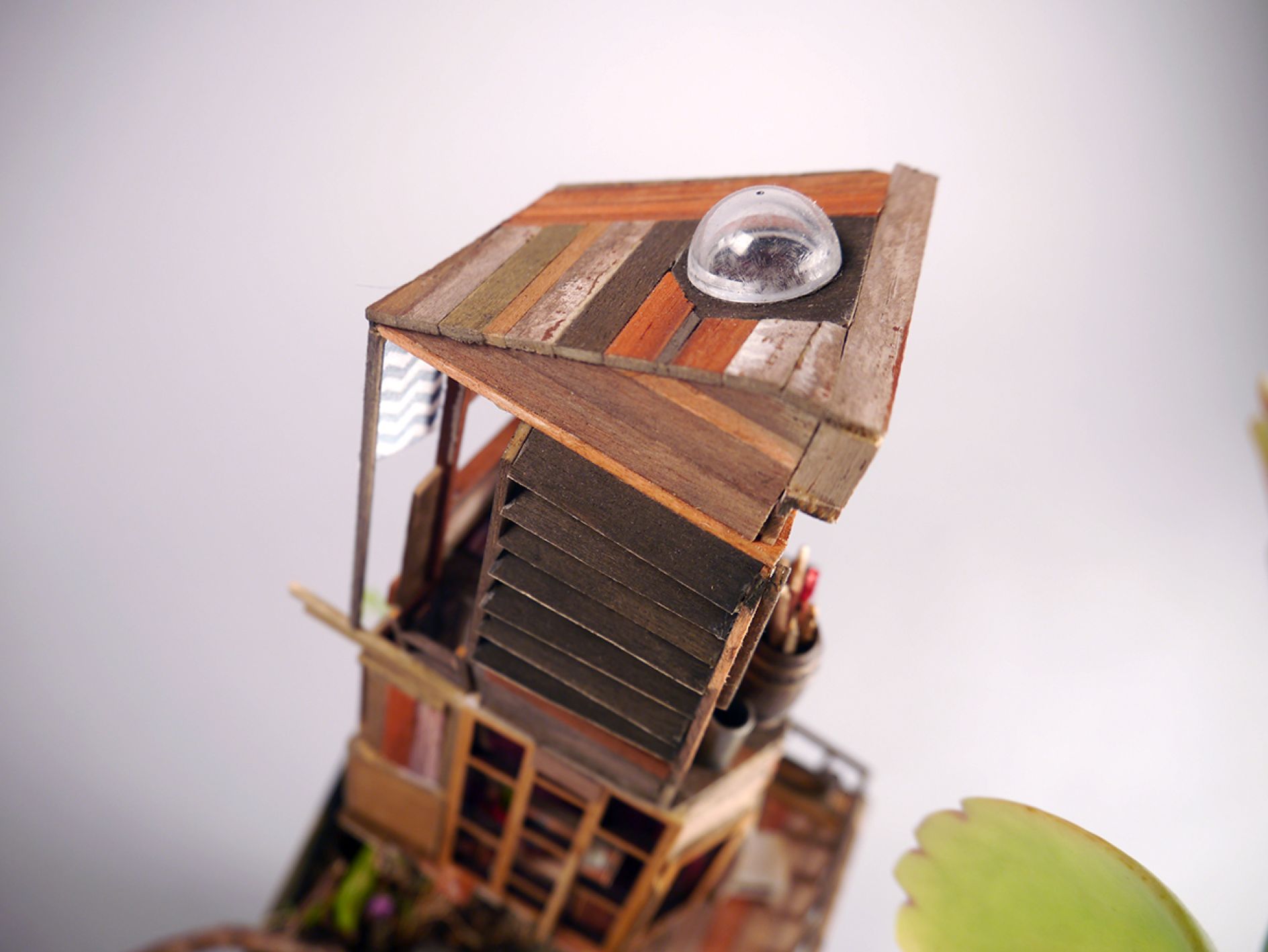Artist crafts miniature treehouse sculptures to sit within ordinary ...