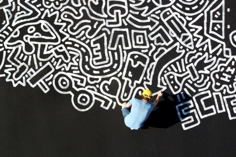 Timothy Goodman paints an entire basketball court for children at a ...