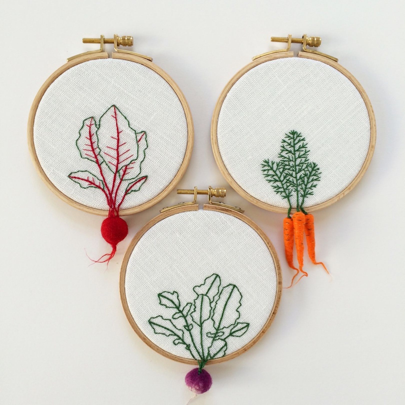 Appetising embroidery art that has crafted vegetables dangling from the ...
