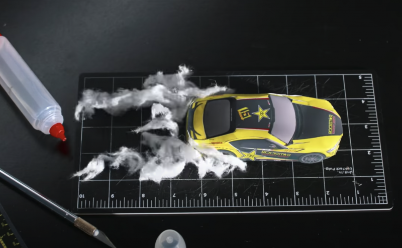 Paper drift cars race around a workshop in a stop motion animated film ...