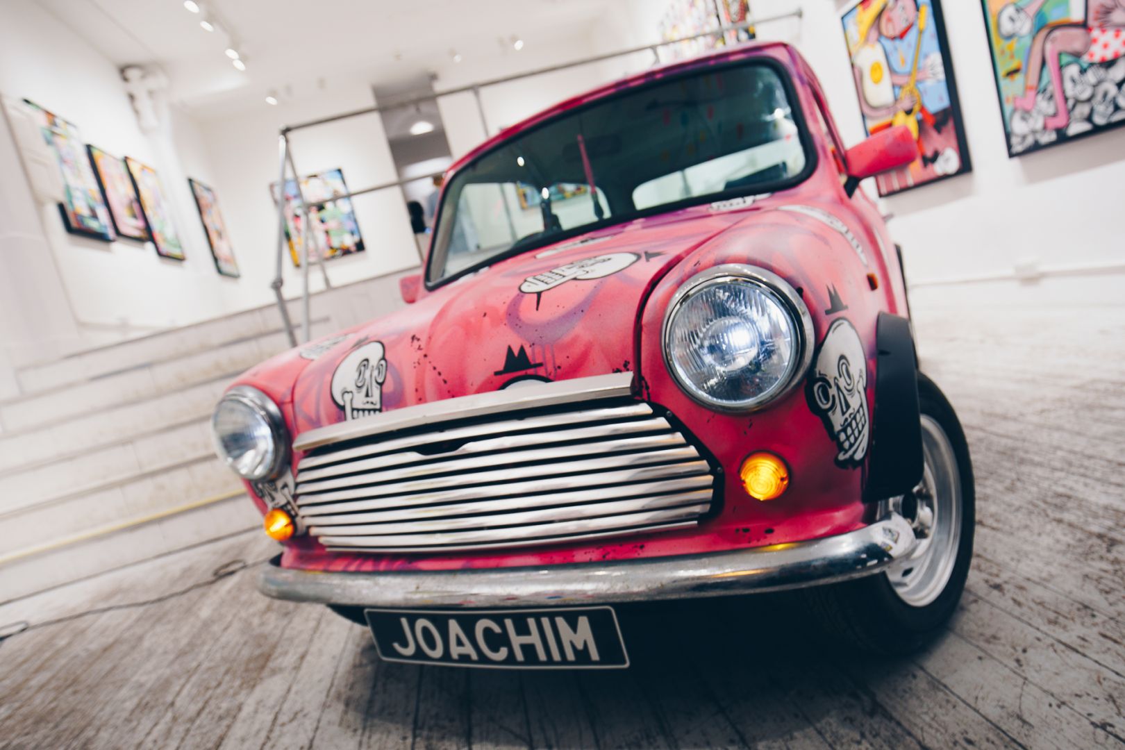 Street artist Joachim drives a pink graffiti-covered Mini Cooper into a ...